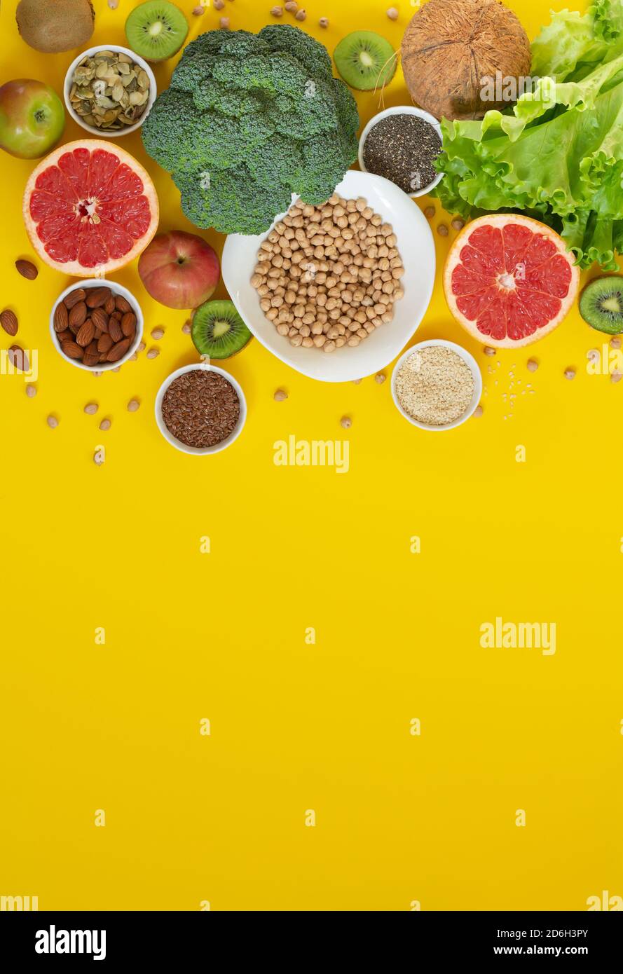 Healthy food background. Different organic groceries on yellow table ...