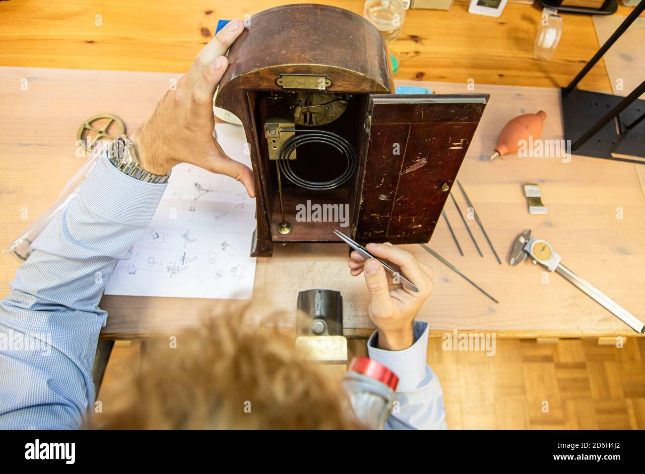 young man assembling mechanical watch. watch production. mans hands ...