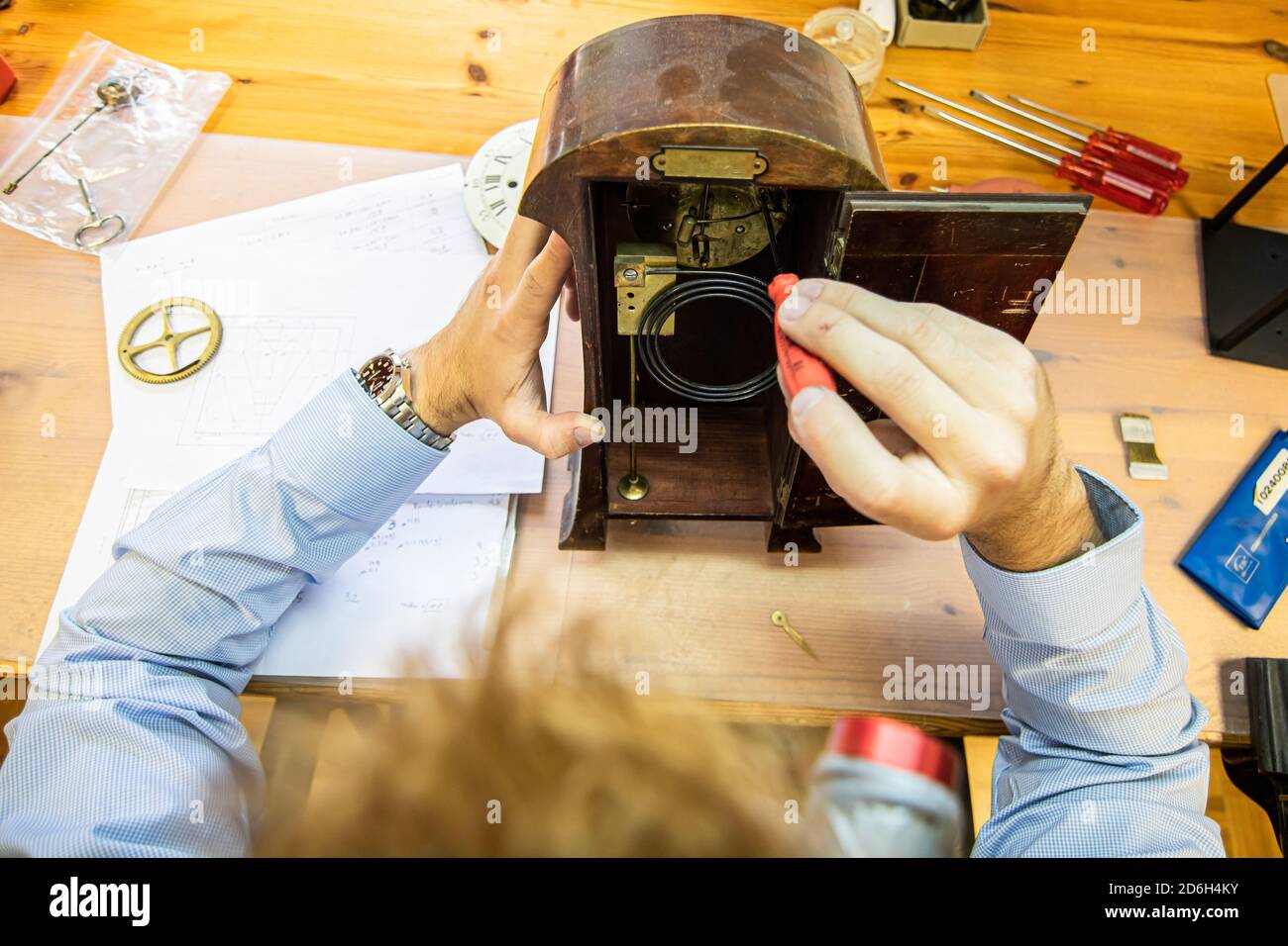 young man assembling mechanical watch. watch production. mans hands ...