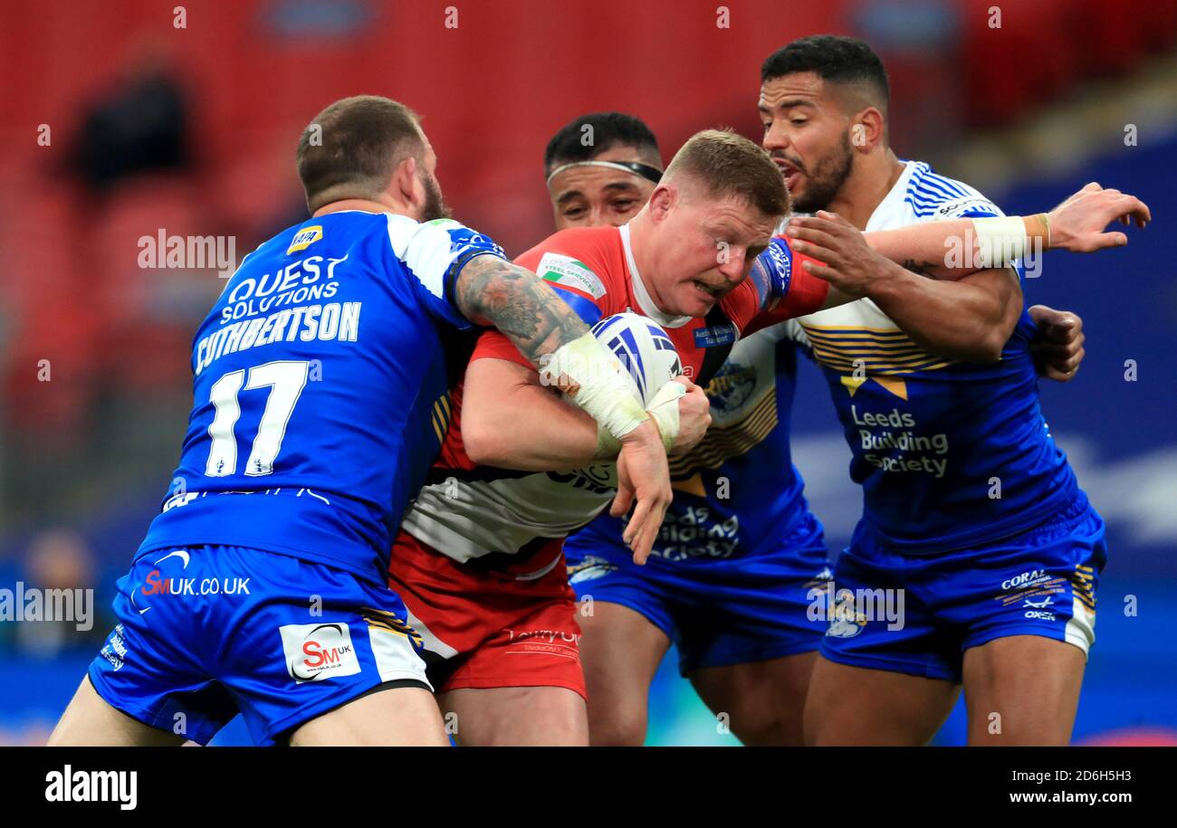 Salford Red Devils' Luke Yates is tackled by Leeds Rhinos' Adam ...