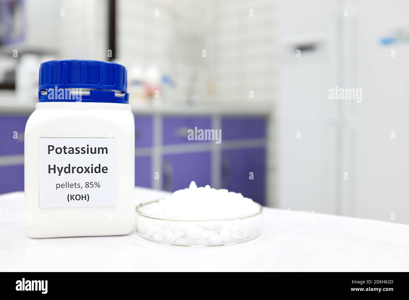 Selective focus of a bottle of pure potassium hydroxide or KOH chemical ...