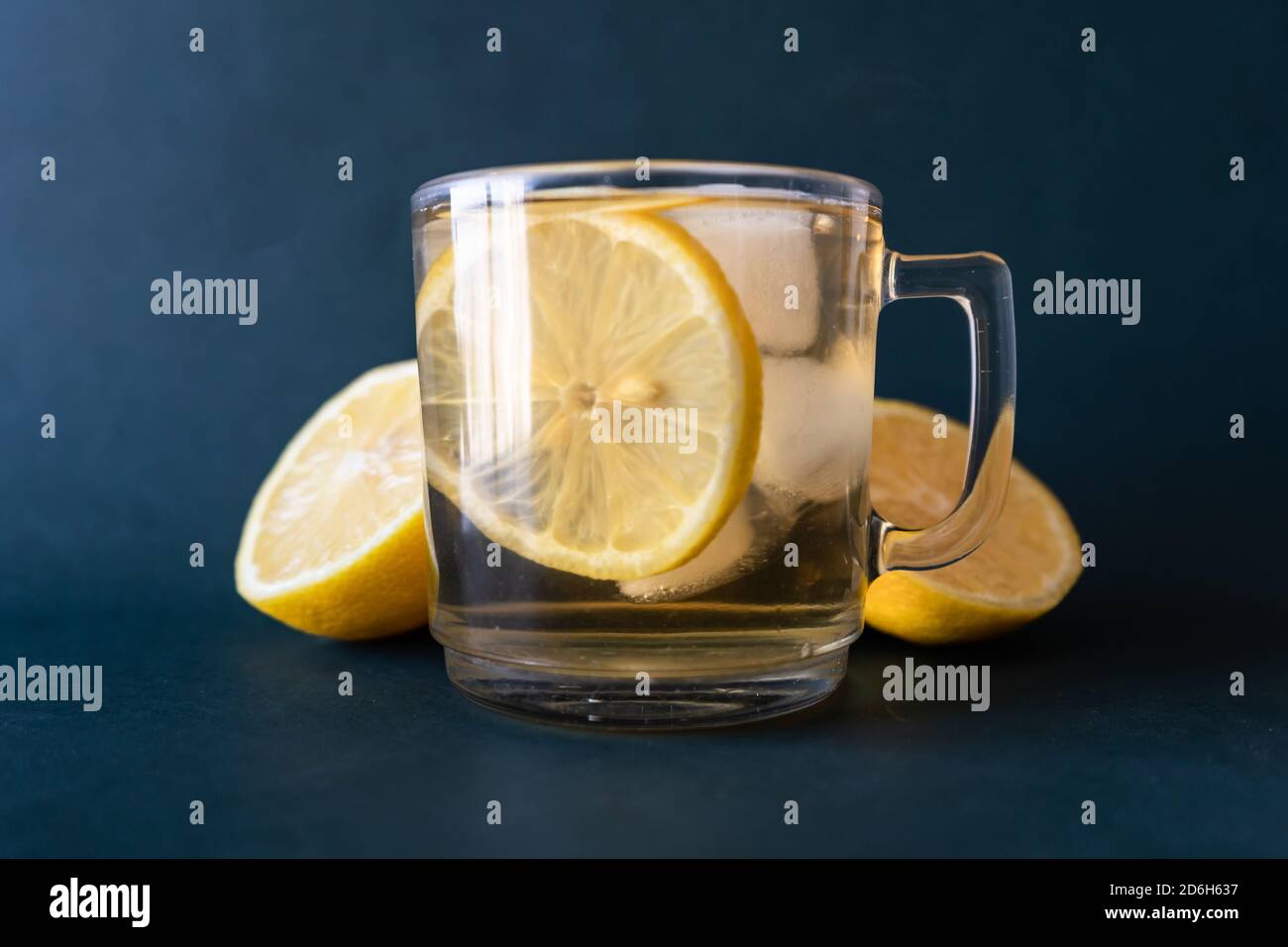 Glass of lemon iced tea on dark background Stock Photo - Alamy