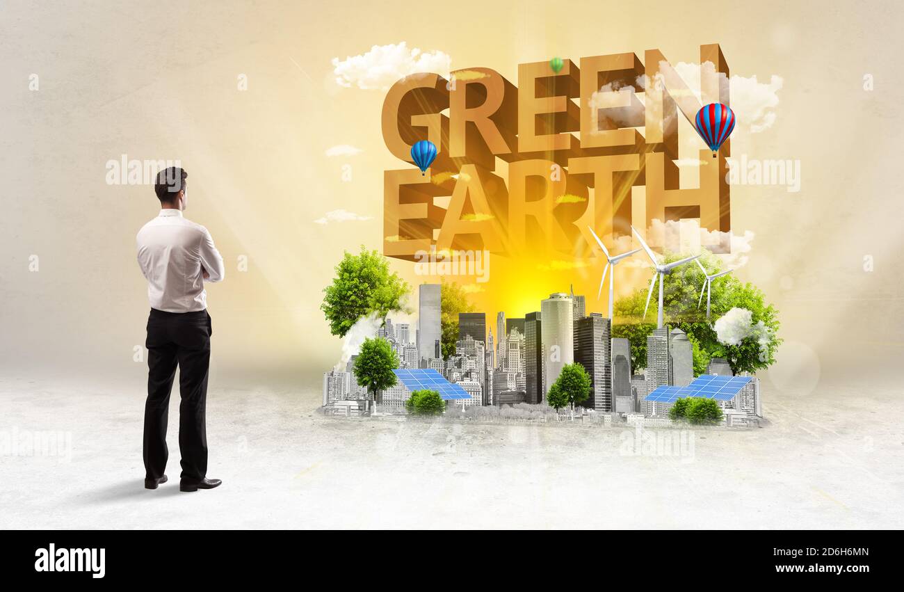 Rear view of a businessman standing in front of GREEN EARTH inscription ...