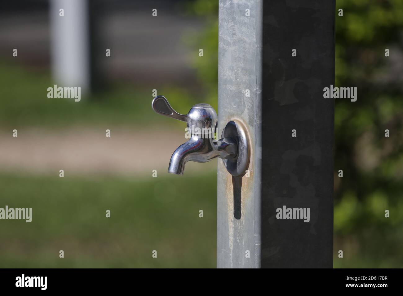 a water tap in a park, blurred background Stock Photo - Alamy