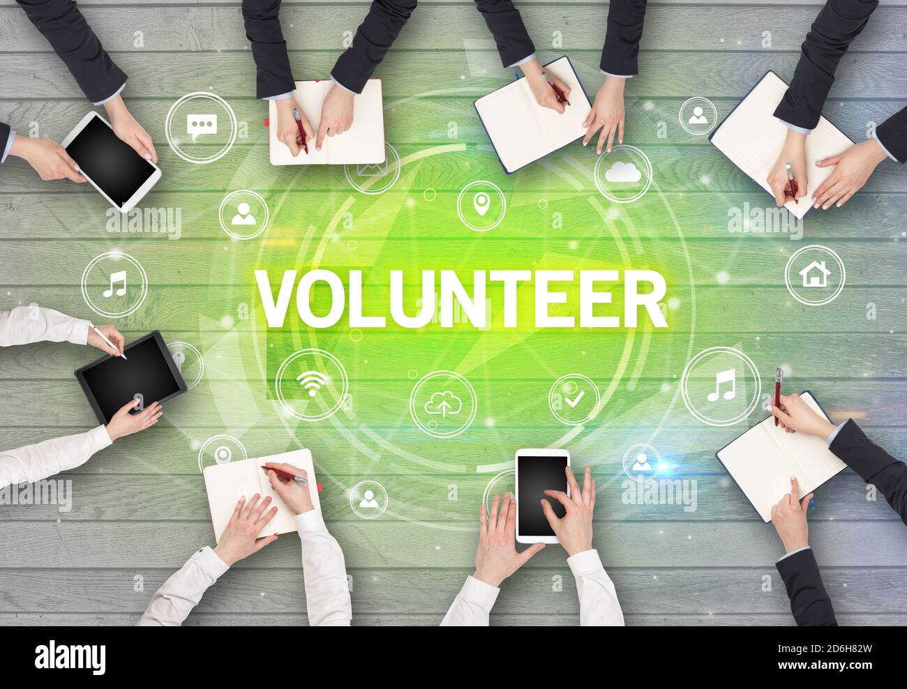 Group of people having a meeting with VOLUNTEER insciption, social ...