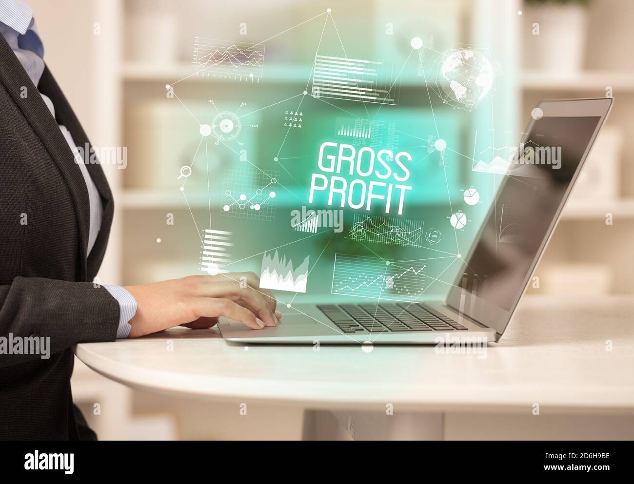 Side view of a business person working on laptop with GROSS PROFIT ...