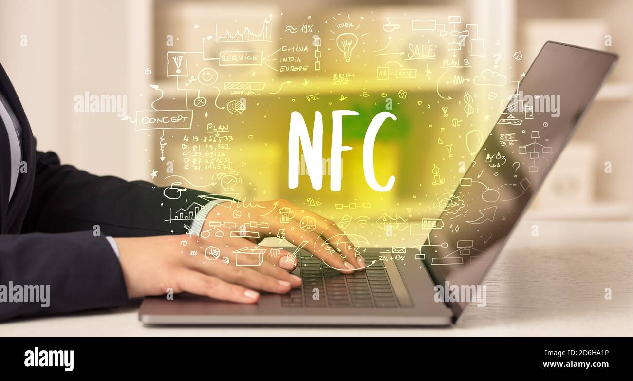 hand working on new modern computer with NFC abbreviation, modern ...