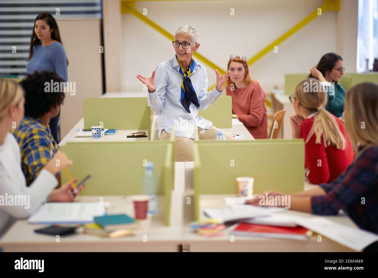 Female professor explaining the lesson to students at a lecture in a ...