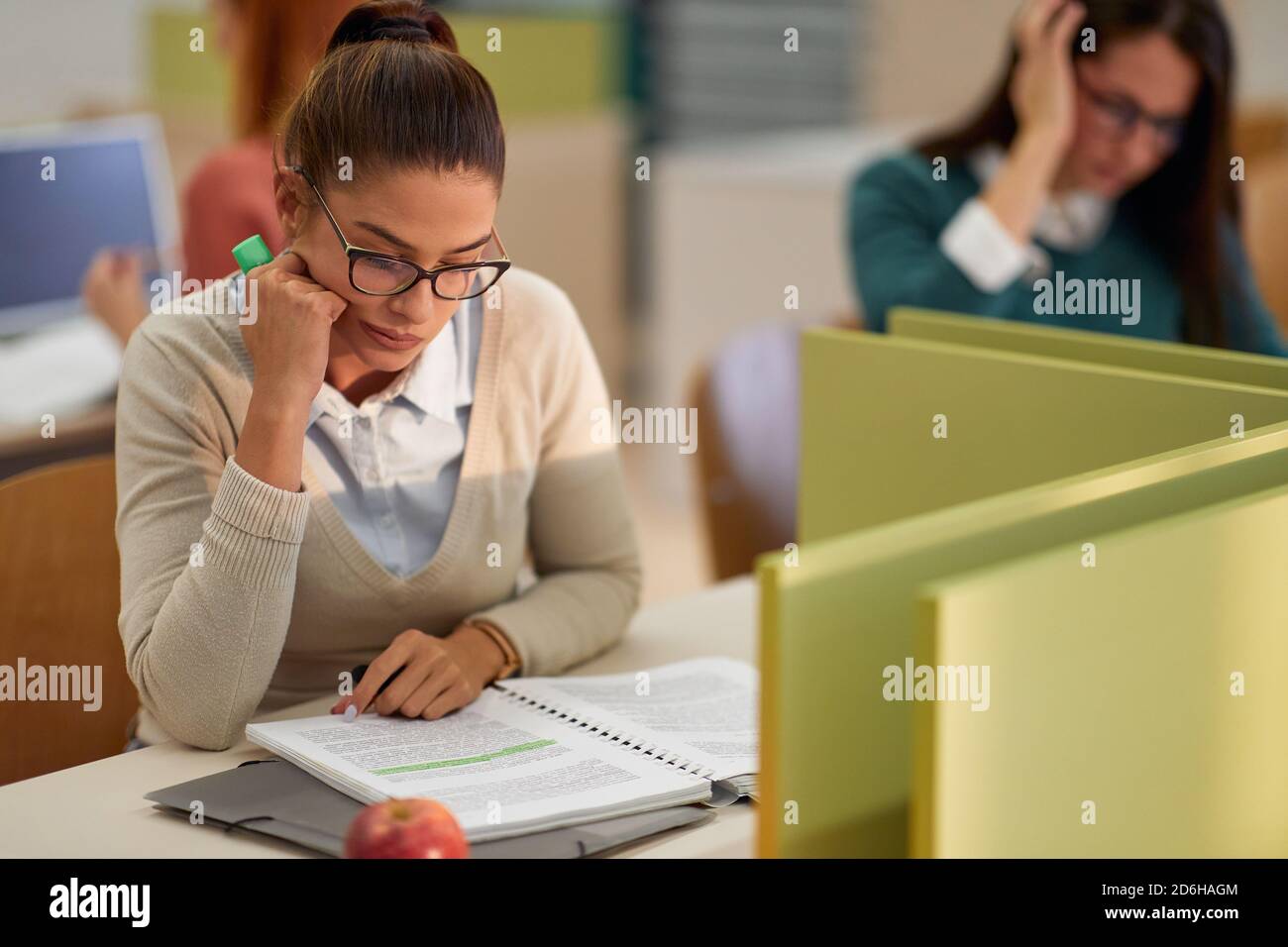 A female student learning a new lesson at the lecture in the university ...