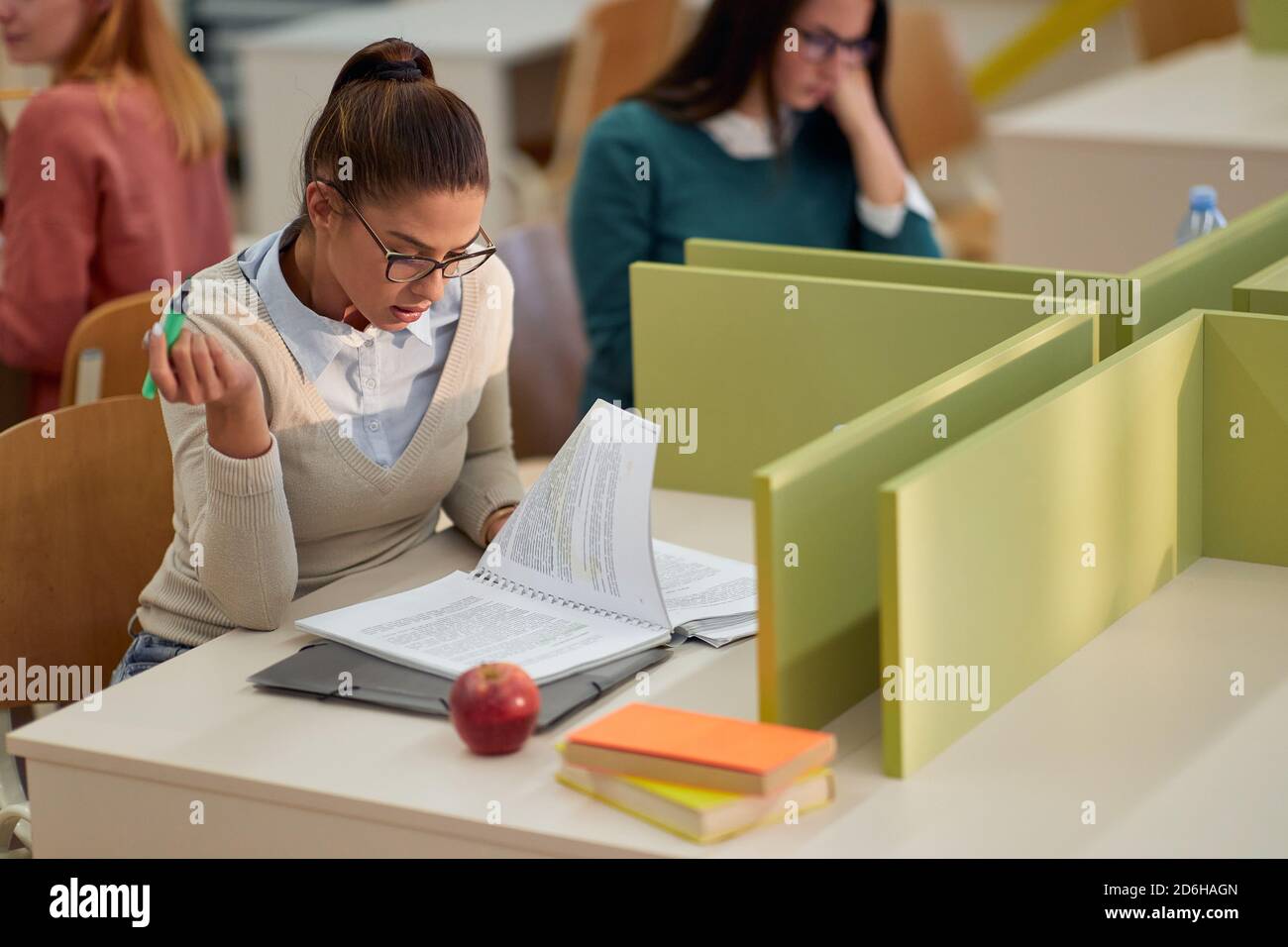 A female student studying a new lesson at the lecture in the university ...