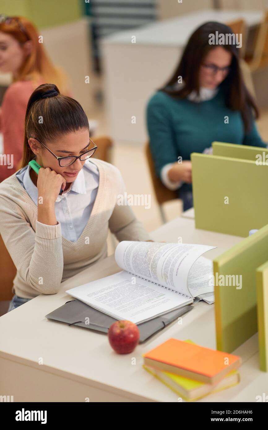 A female student carefully passing through a lesson at the lecture in ...