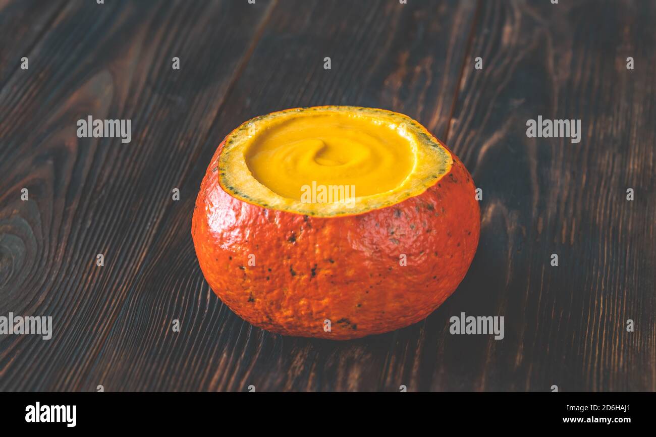 Pumpkin soup served in the hollowed out hokkaido pumpkin Stock Photo ...