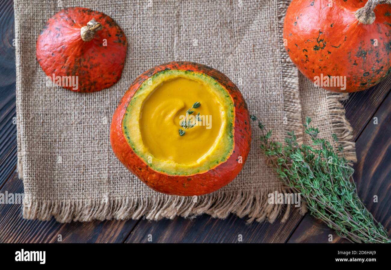 Pumpkin soup served in the hollowed out hokkaido pumpkin Stock Photo ...