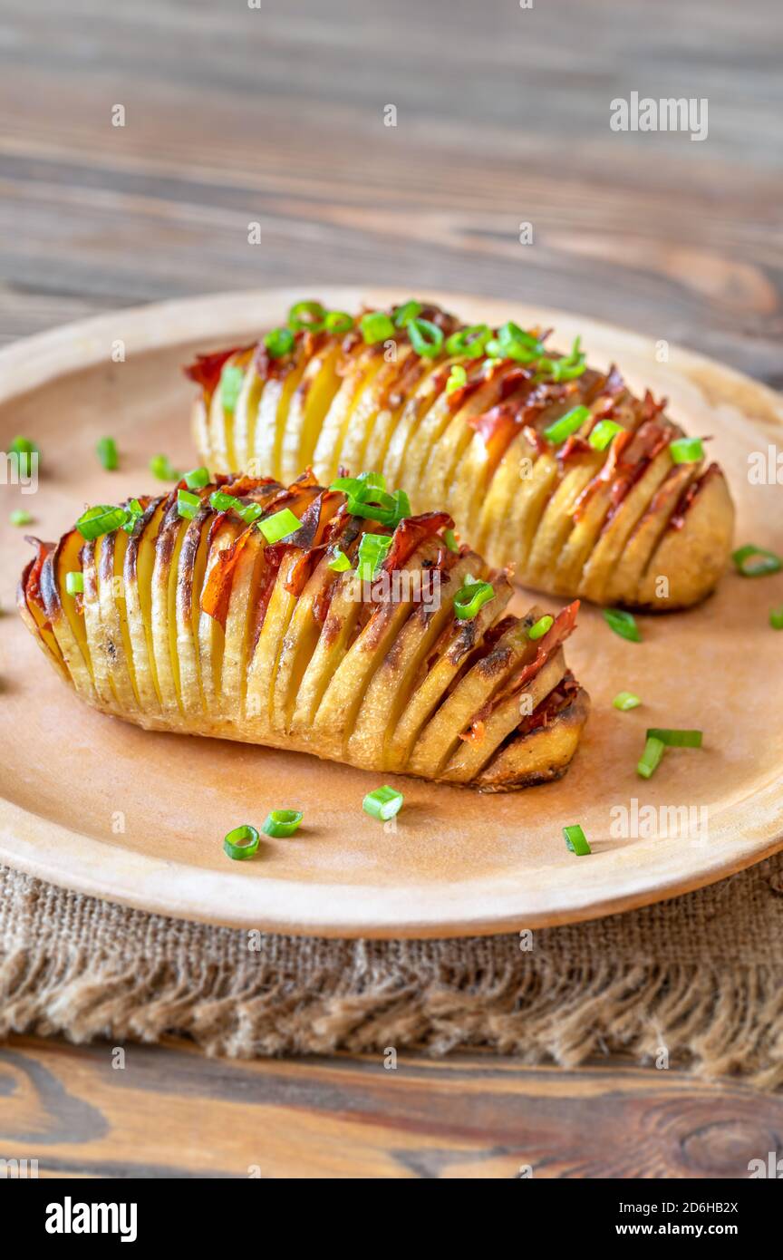 Hasselback potatoes on a plate Stock Photo - Alamy