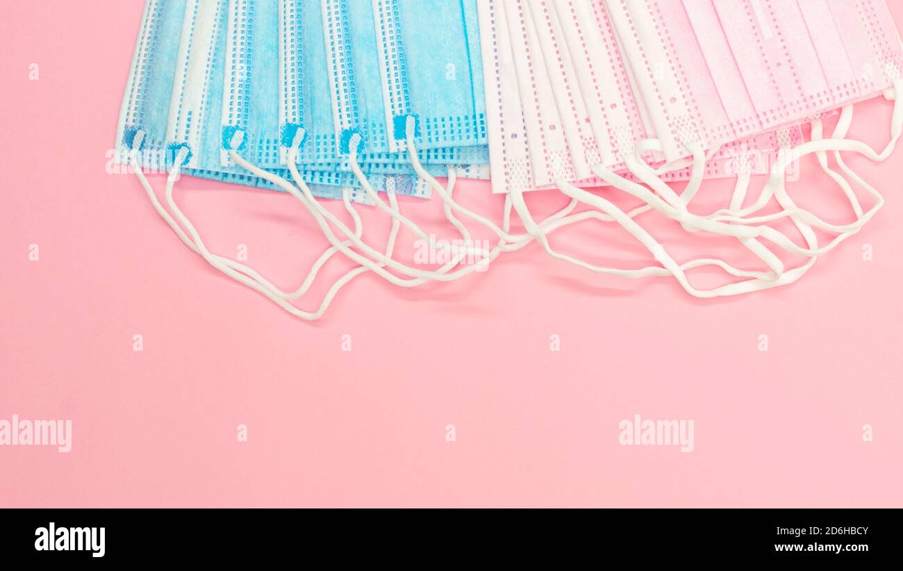 High angle shot of surgical masks on a pink surface Stock Photo - Alamy