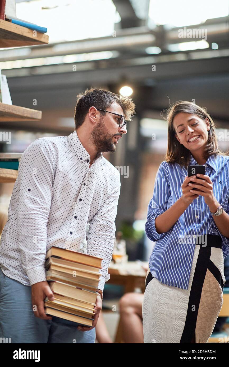 Couple standing library holding hi-res stock photography and images - Alamy