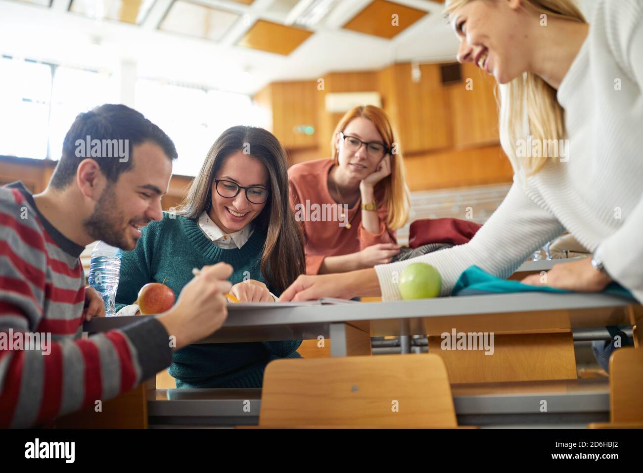 Group of students talking about the lesson on the lecture break in the ...