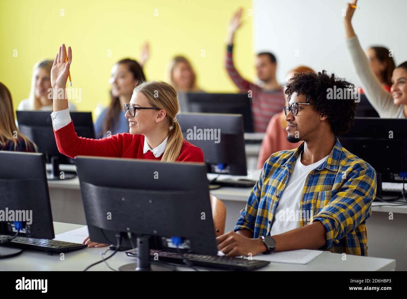 Classroom raising their hands hi-res stock photography and images - Alamy