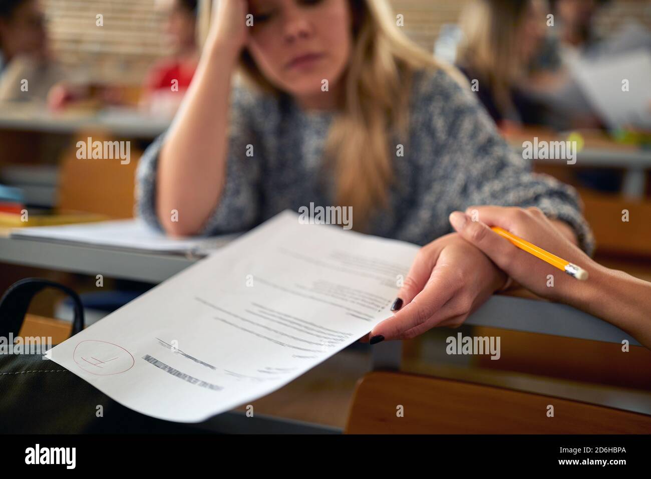 Sad girl sitting in classroom hi-res stock photography and images - Alamy