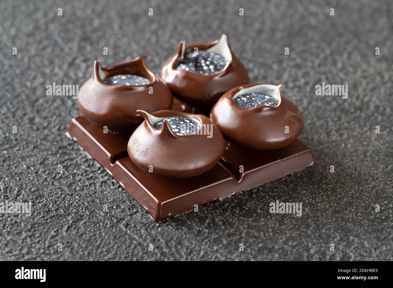 Handcrafted chocolate candies on black background Stock Photo - Alamy