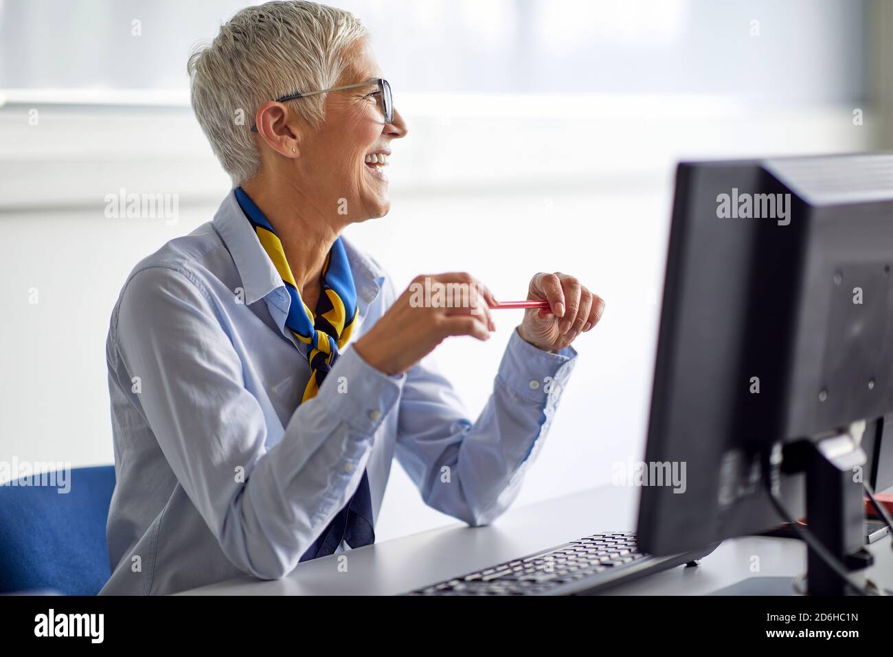 A cheerful female professor at a lecture in the university classroom ...