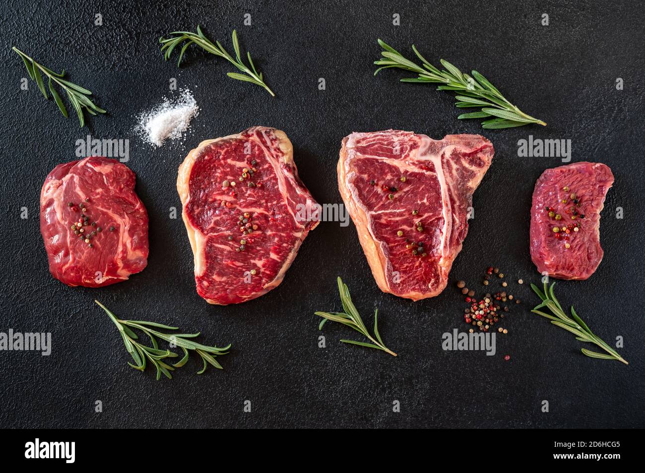 Variety of beef steaks on dark background Stock Photo - Alamy