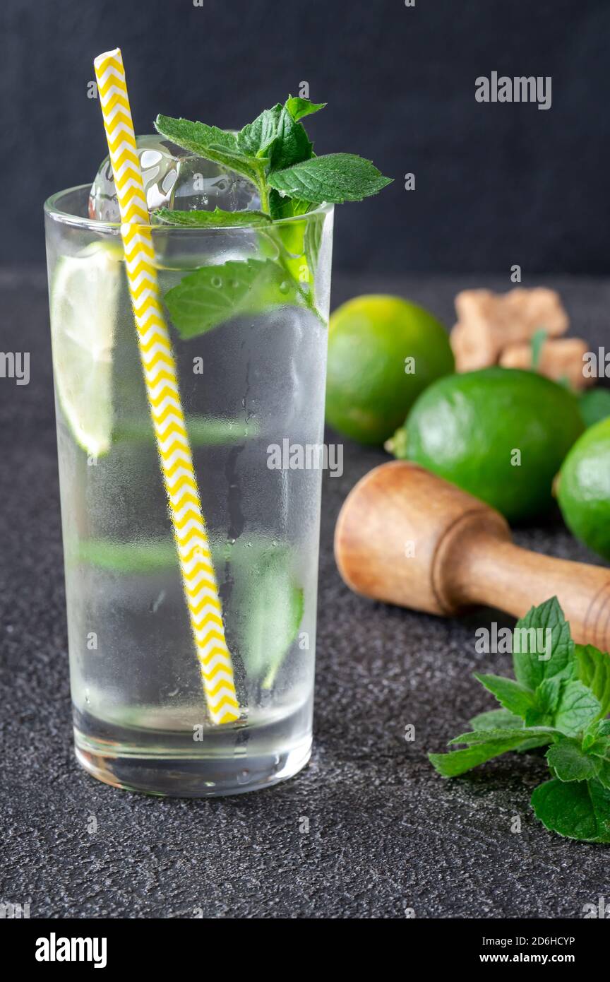 Glass of mojito cocktail with ingredients on dark background Stock ...