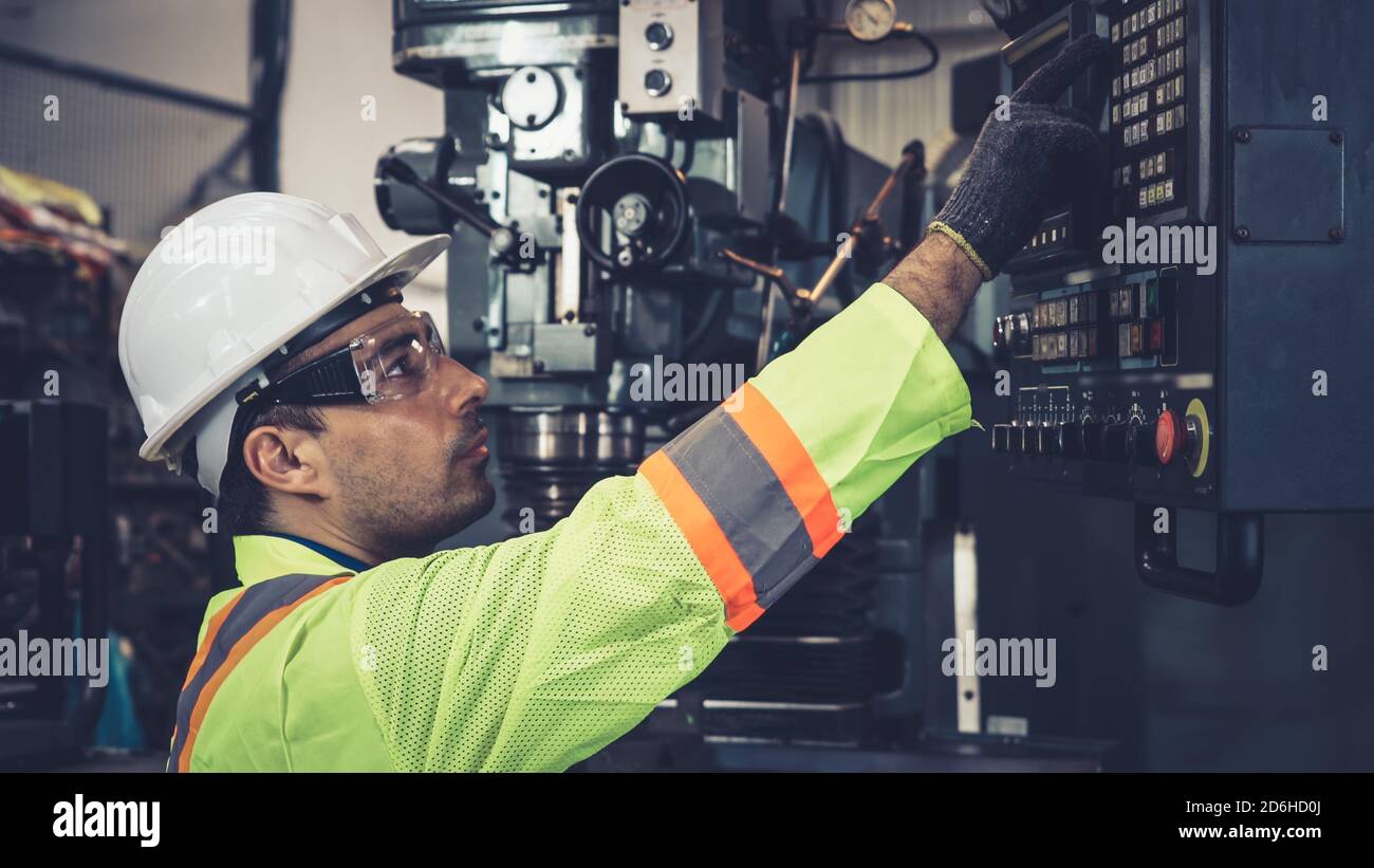 Smart factory worker using machine in factory workshop . Industry and ...