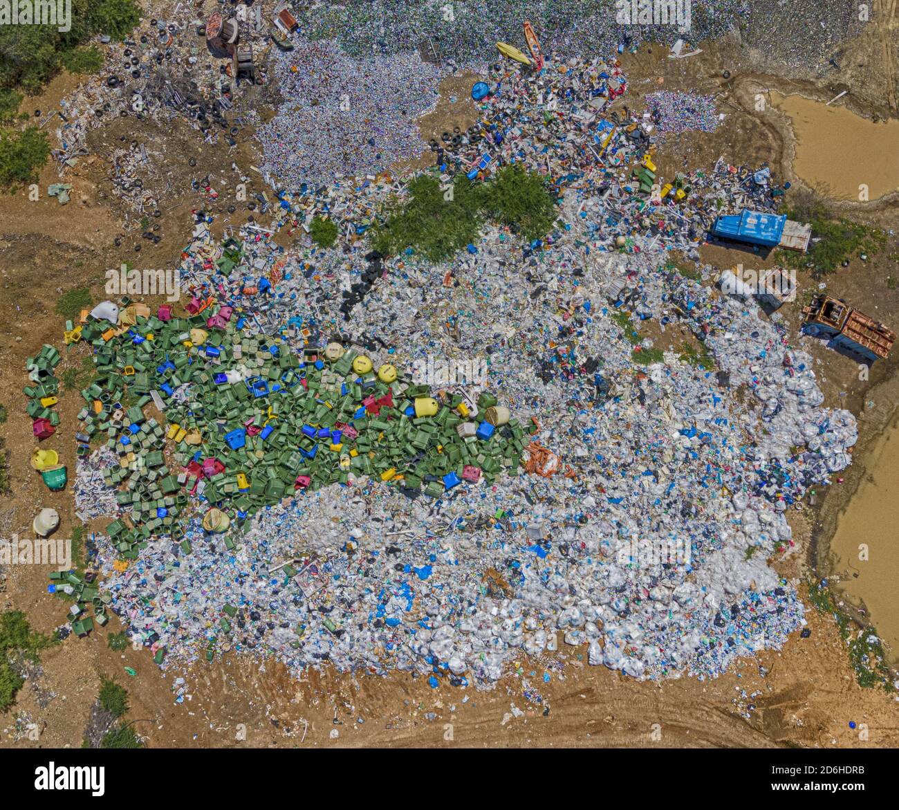 Old garbage boxes in green, with plastic bags on the garbage dump Stock ...
