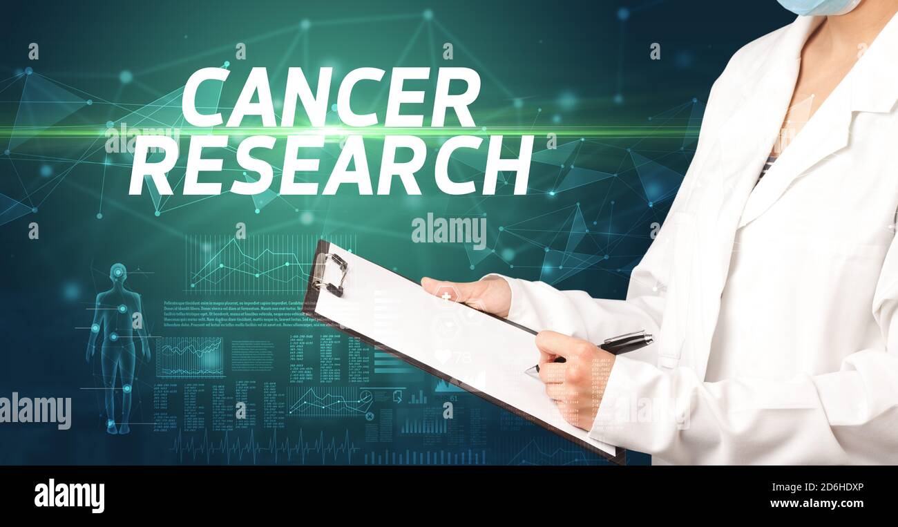 doctor writes notes on the clipboard with CANCER RESEARCH inscription ...