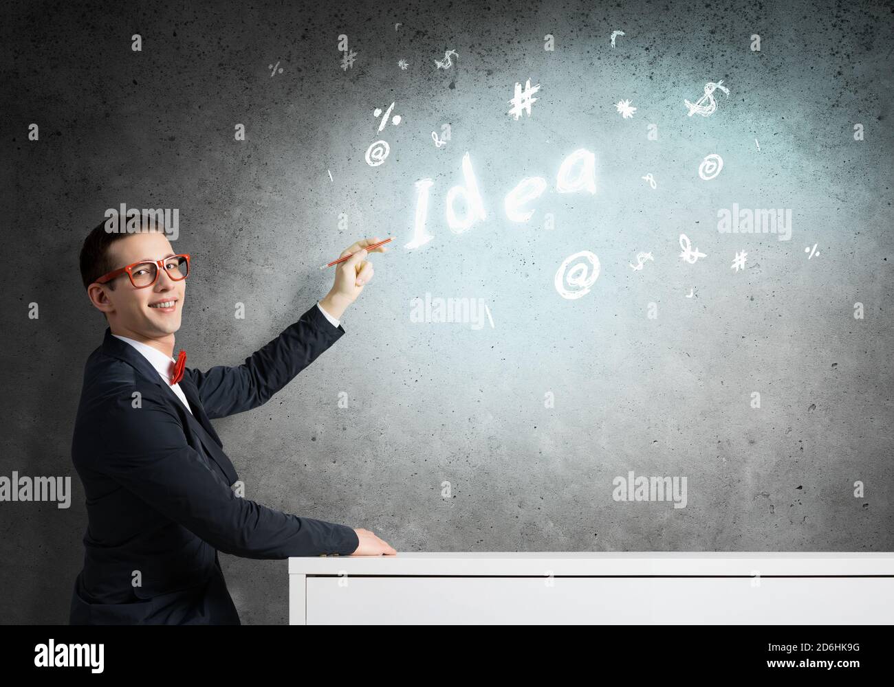 Smart guy draw on wall Stock Photo - Alamy