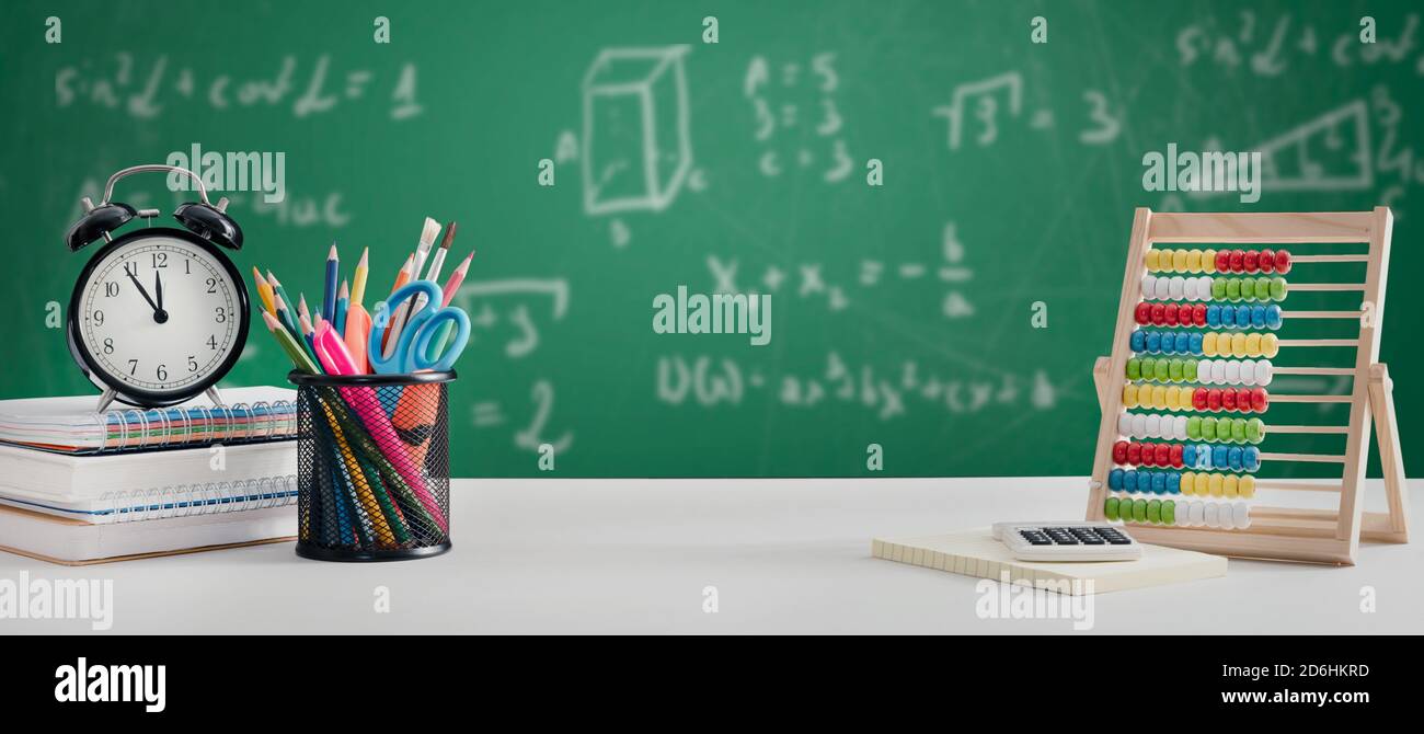Back to school, student stuff on desk, board in background Stock Photo ...
