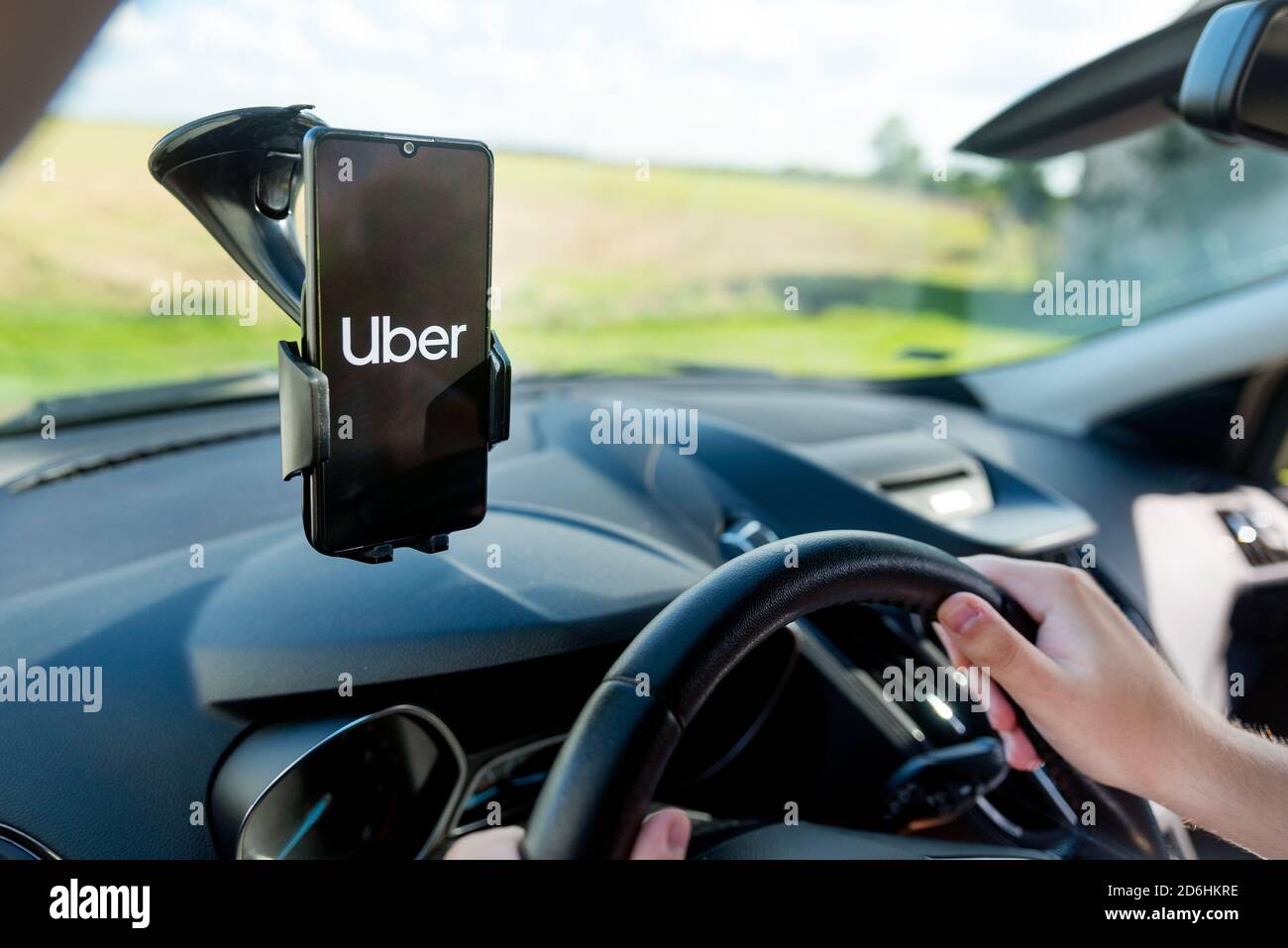 Wroclaw, Poland - AUG 25, 2020: Uber driver holding smartphone in car ...
