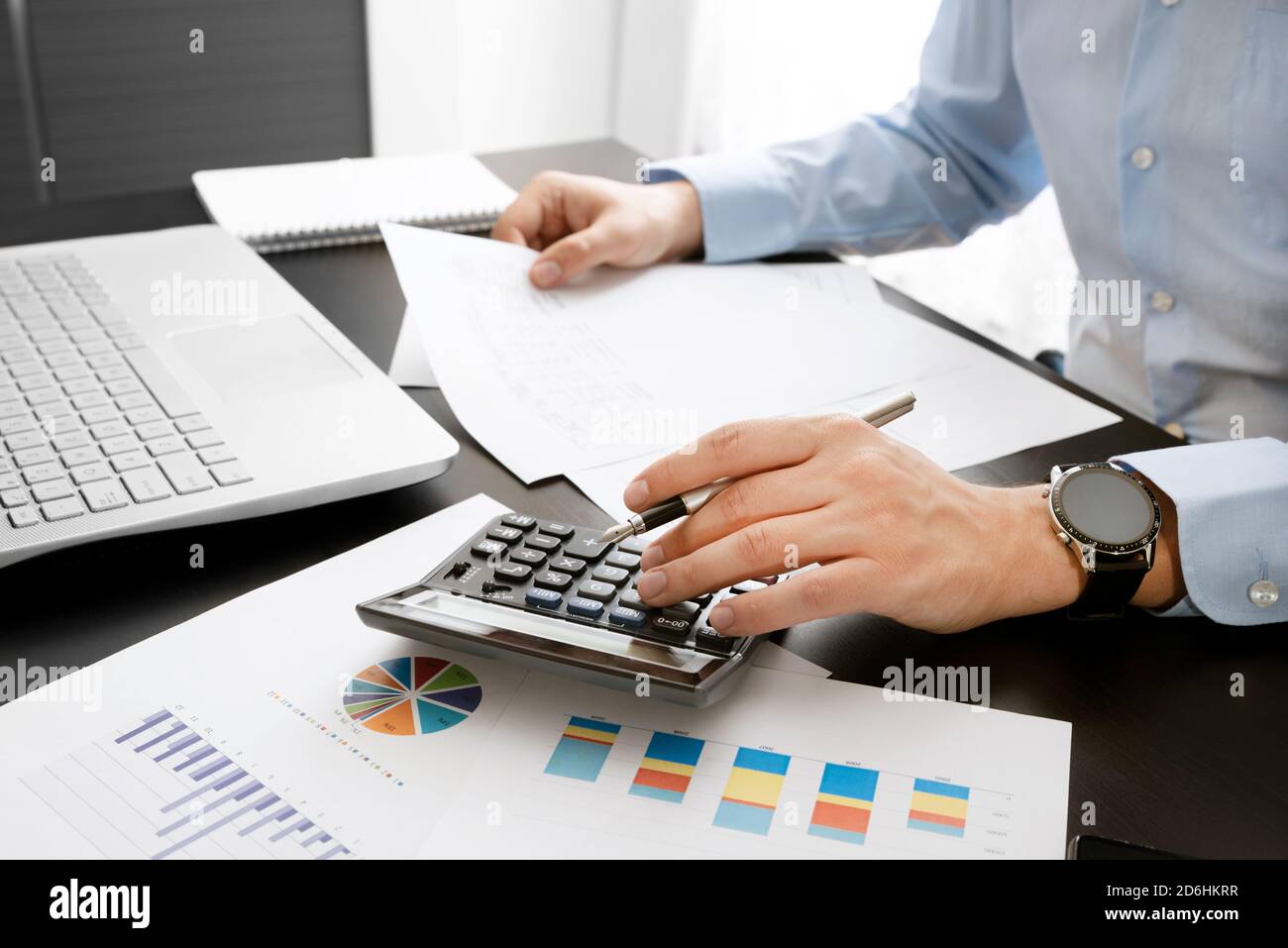 Accountant at work in the office. Man calculates income and expenses ...