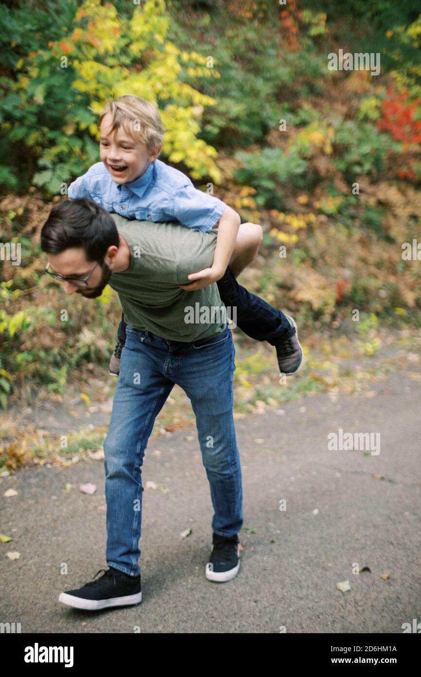 Boy carries sister on back hi-res stock photography and images - Alamy