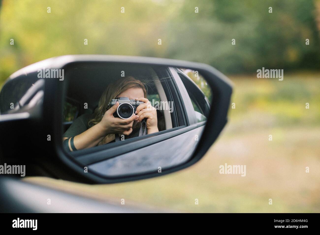 Reflection happy young woman rear view mirror car hi-res stock ...