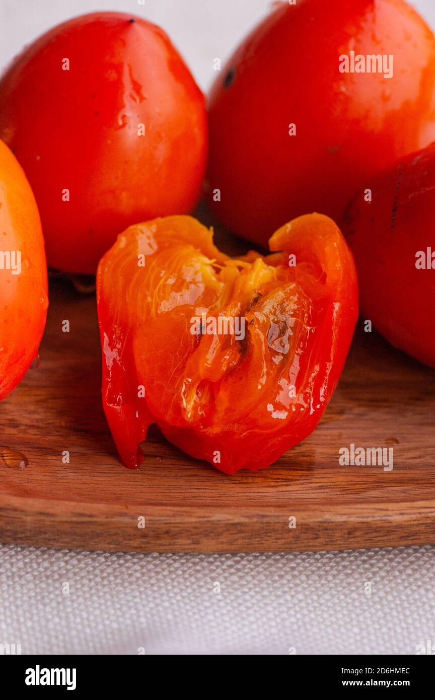 Two fresh organic persimmons hi-res stock photography and images - Alamy