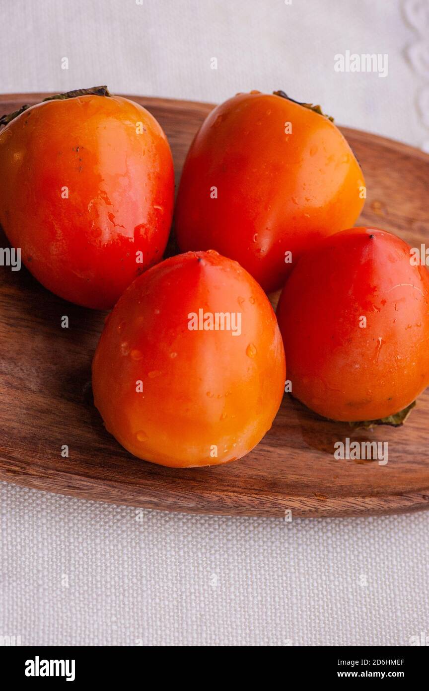 Persimmon fruit healthy food vitamins. Two persimmons Stock Photo - Alamy