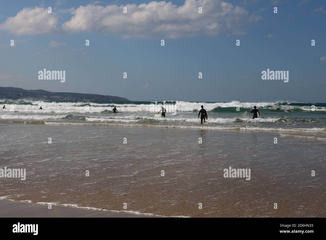 Surfers on the sandy beach, Hayle, Cornwall, United Kingdom. 15/10/2020 ...