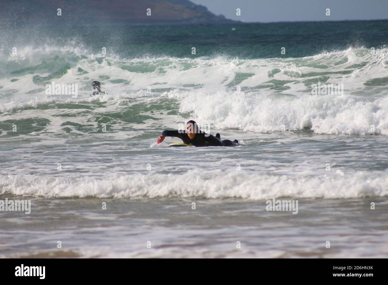 Surfers on the sandy beach, Hayle, Cornwall, United Kingdom. 15/10/2020 ...