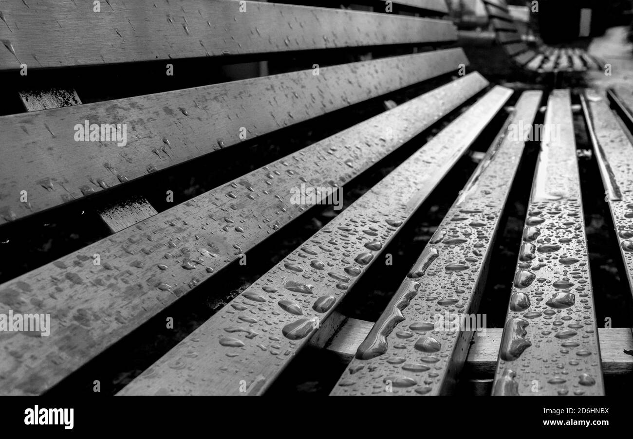 Close-up of wet stainless steel lated bench seating Stock Photo - Alamy