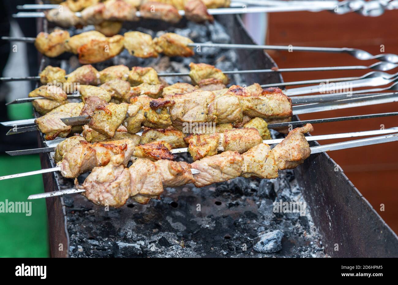 Grilled appetizing kebab cooking on metal skewers. Shashlik during of ...