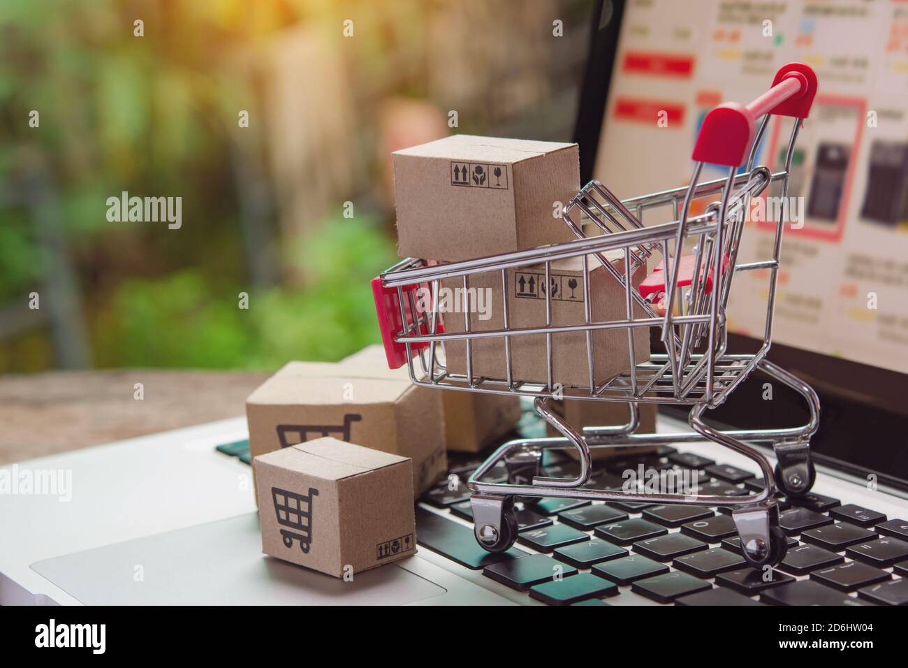 Shopping online. cardboard box with a shopping cart logo in a trolley ...