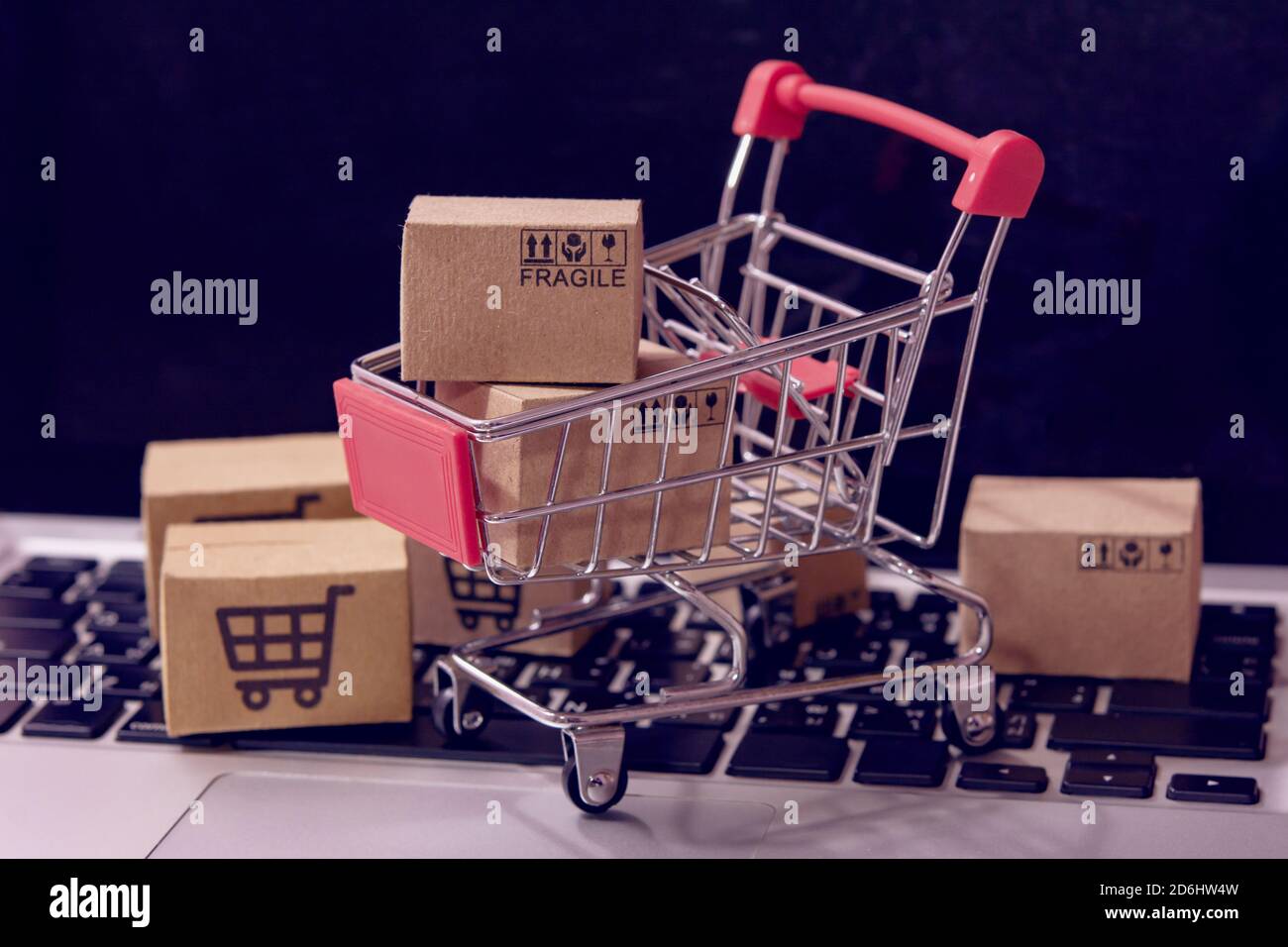 Shopping online. cardboard box with a shopping cart logo in a trolley ...