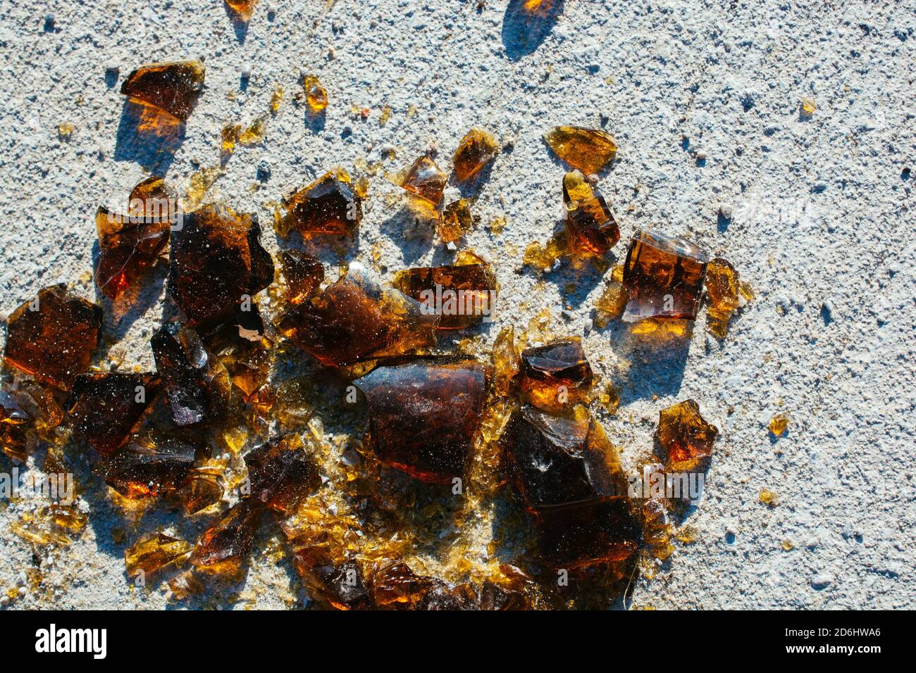 Top view of shattered glass on a textured white cement surface Stock ...