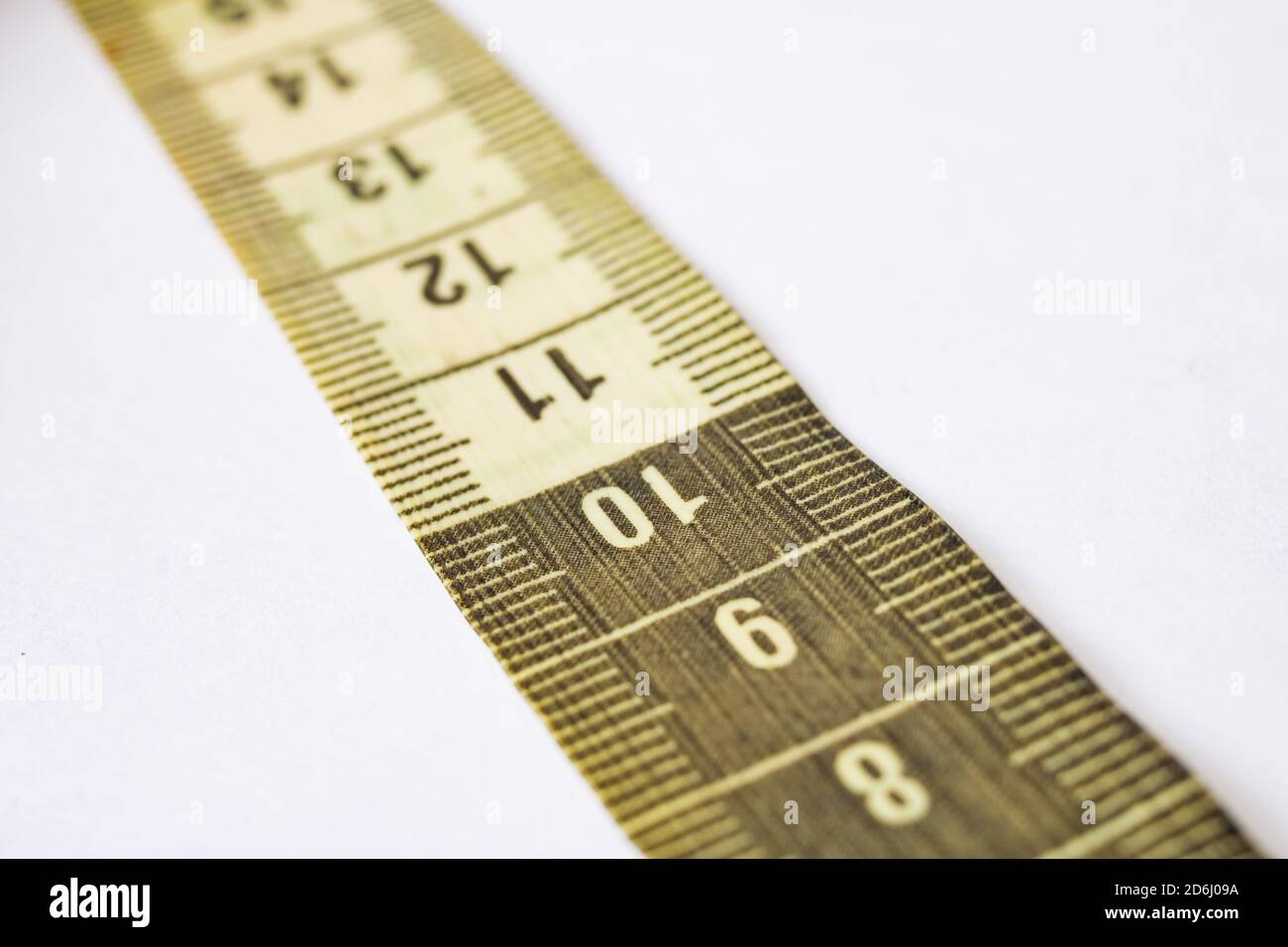 Yellow measuring tape isolated on white background Stock Photo - Alamy