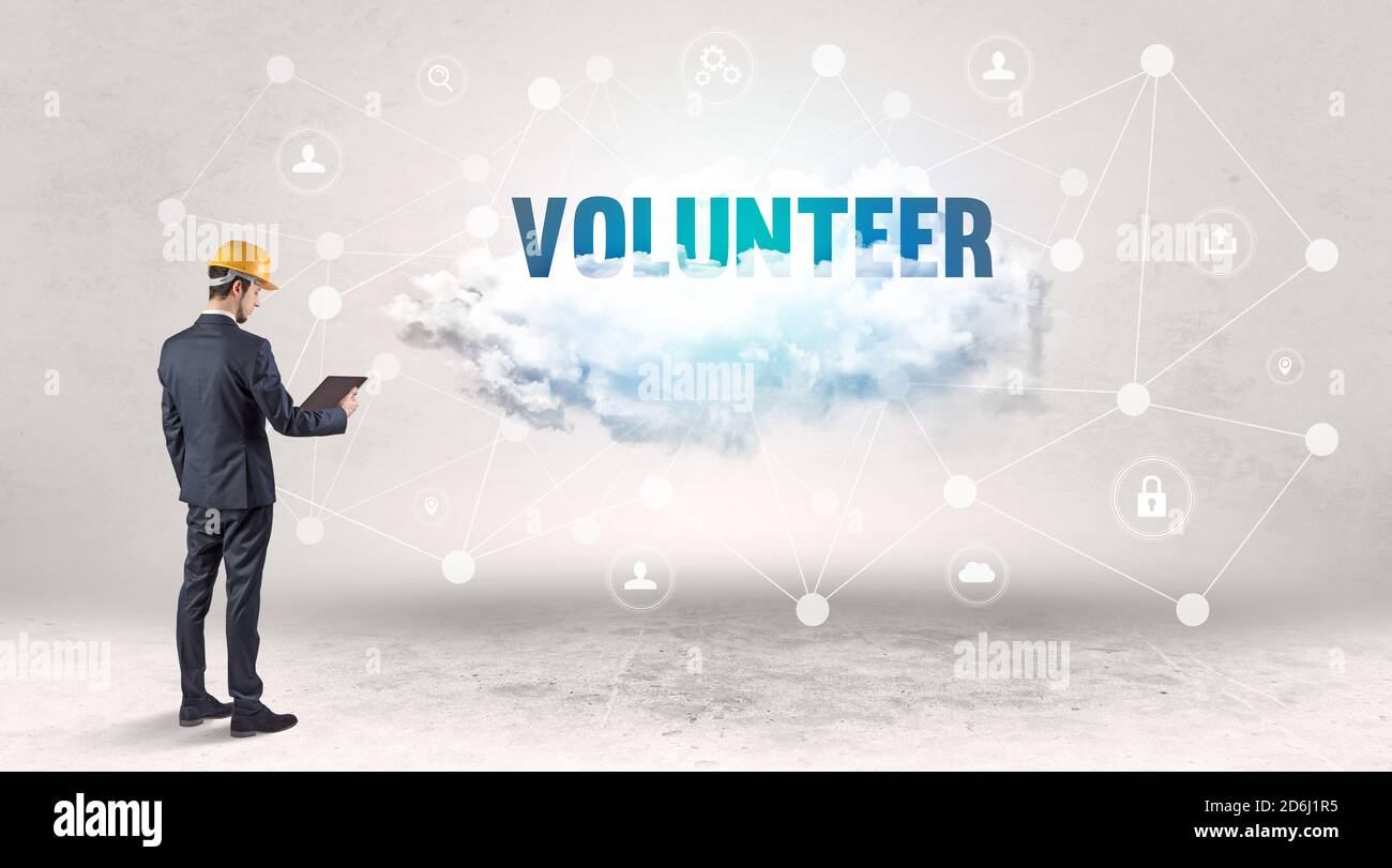 Engineer working on a social media concept with VOLUNTEER inscription ...