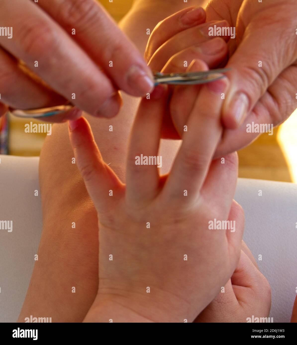 Detail of the hands of a woman cutting the nails of a child Stock Photo ...