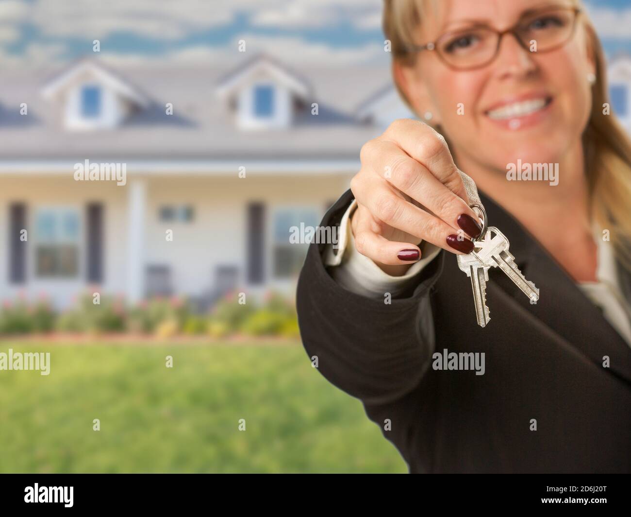Real Estate Agent Handing Over New House Keys with House Behind Stock ...