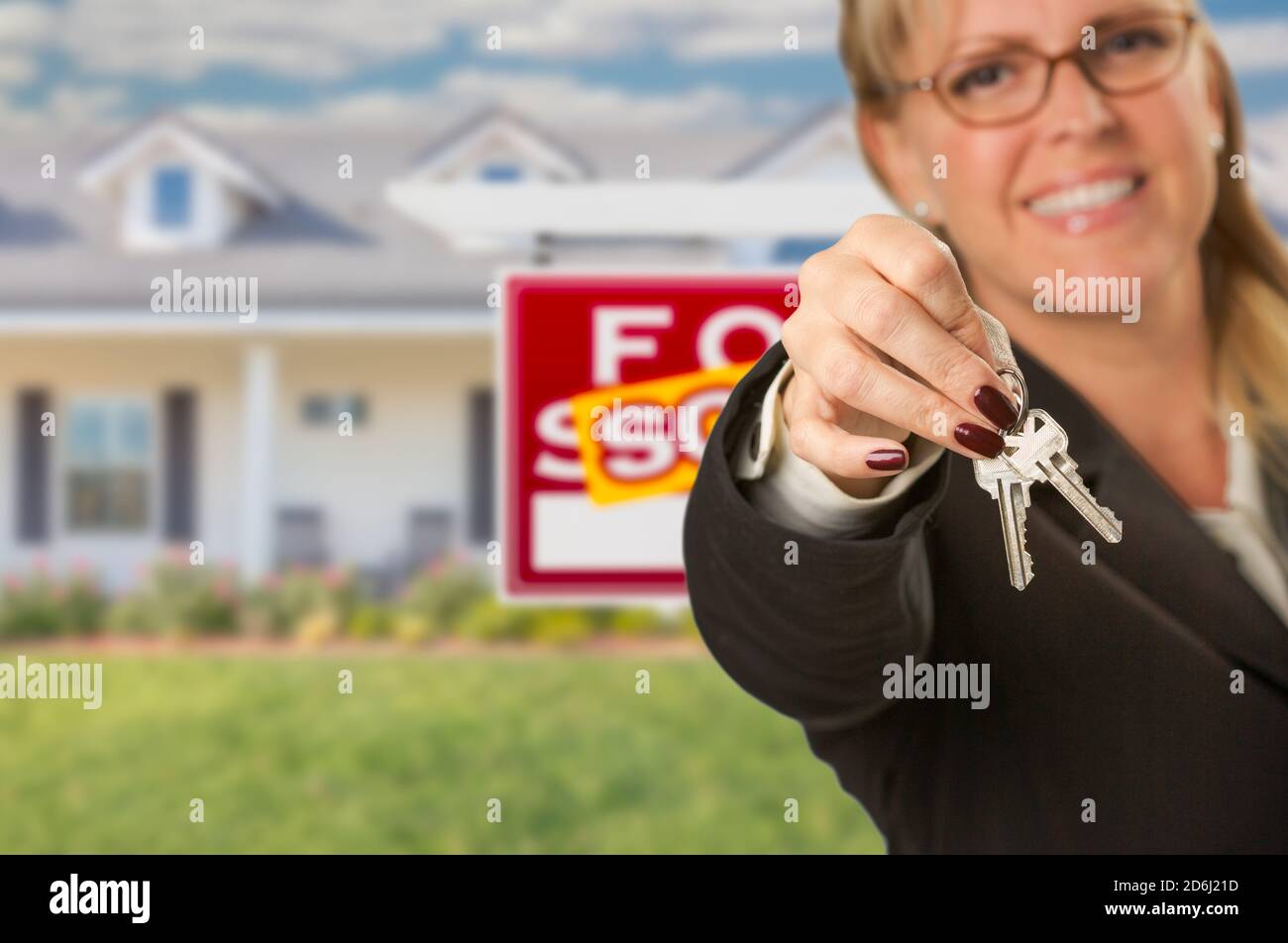 Real Estate Agent Handing Over New House Keys with Sold Sign Behind ...
